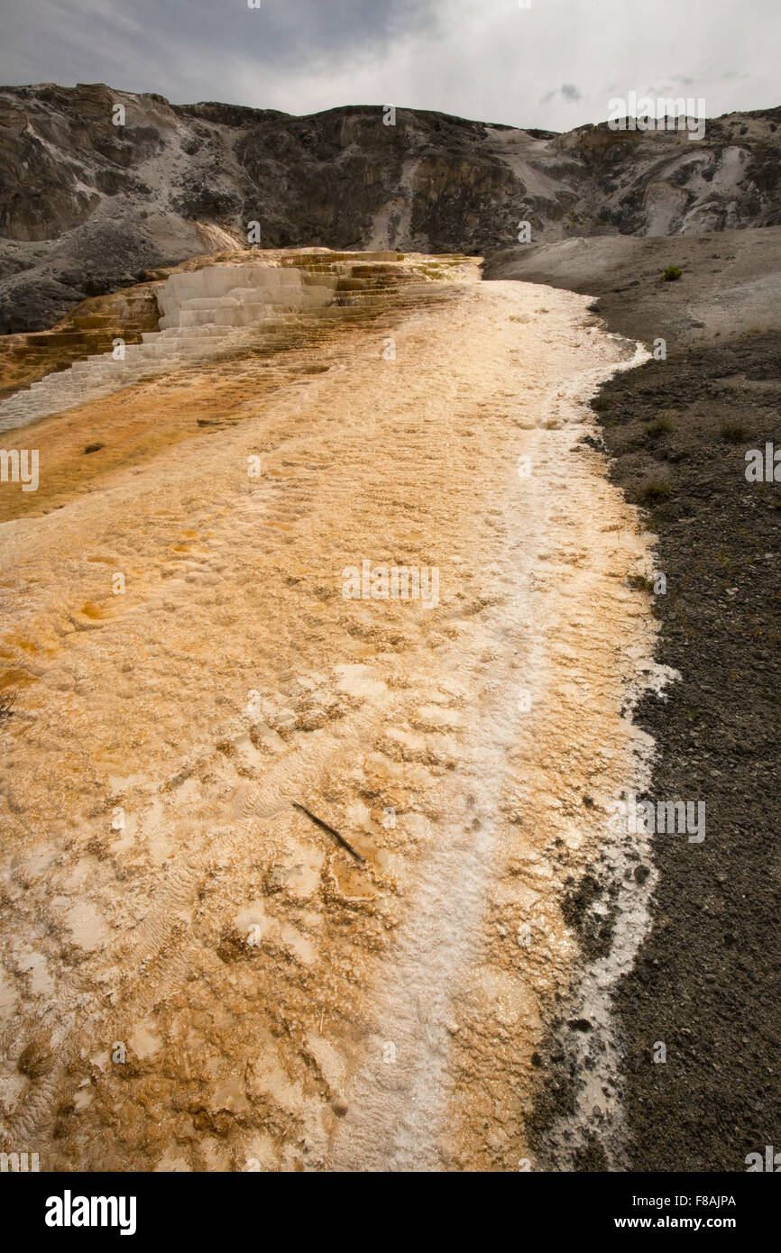 Geothermal flow of hot, carbonate rich water out of orange travertine ...