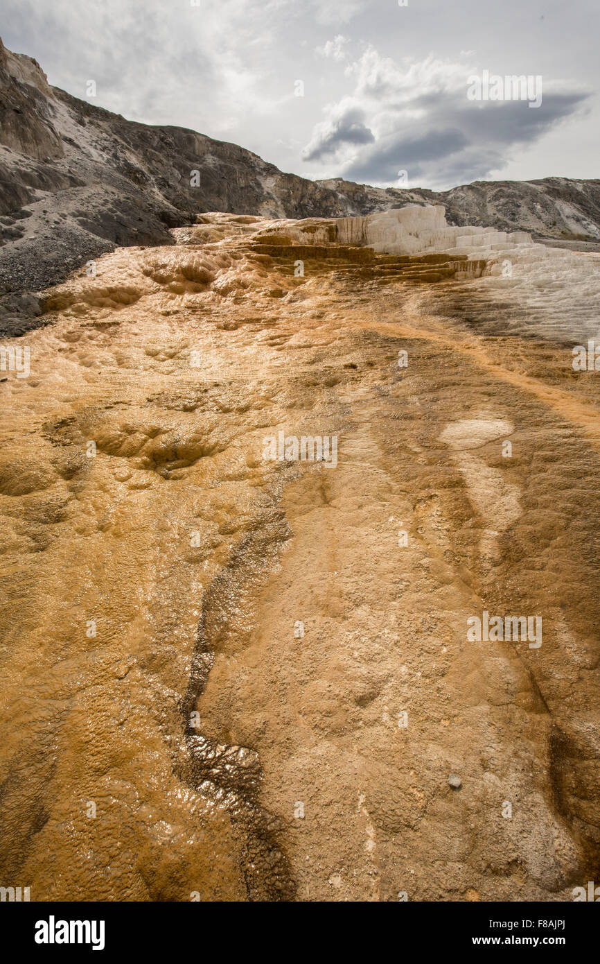 Geothermal flow of hot, carbonate rich water out of orange travertine ...