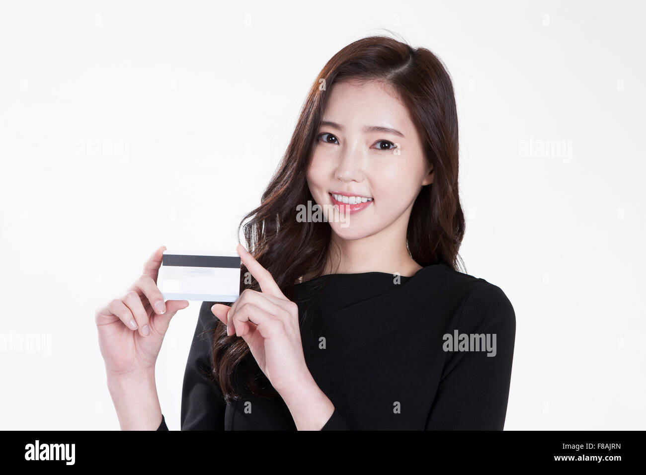 Credit card held by a woman in black dress with a long hair staring ...
