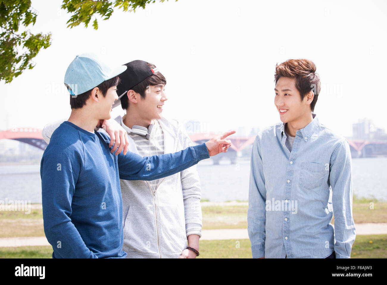 Three young men smiling hi-res stock photography and images - Alamy