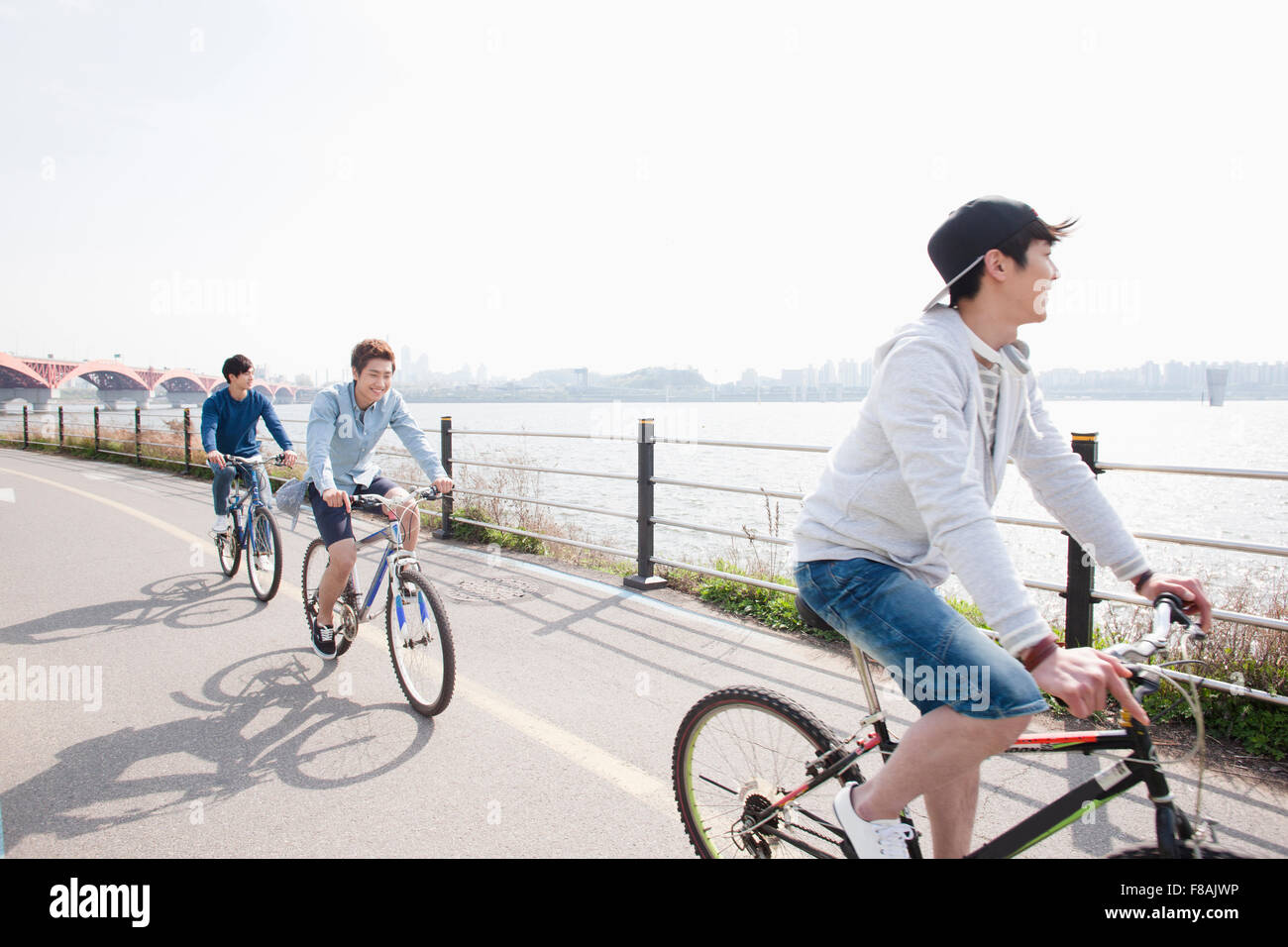 Three young men smiling hi-res stock photography and images - Alamy