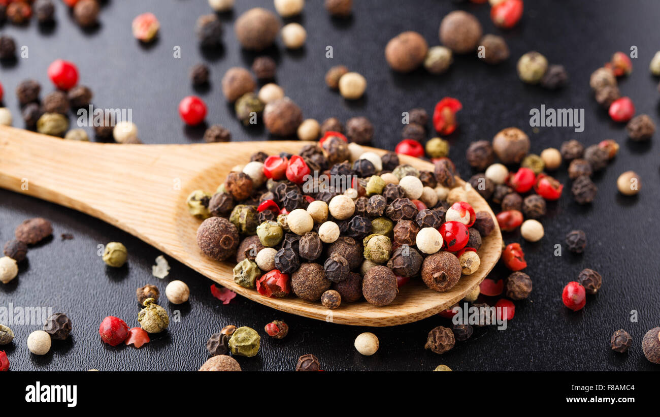Mixed peppers on a wooden spoon Stock Photo - Alamy