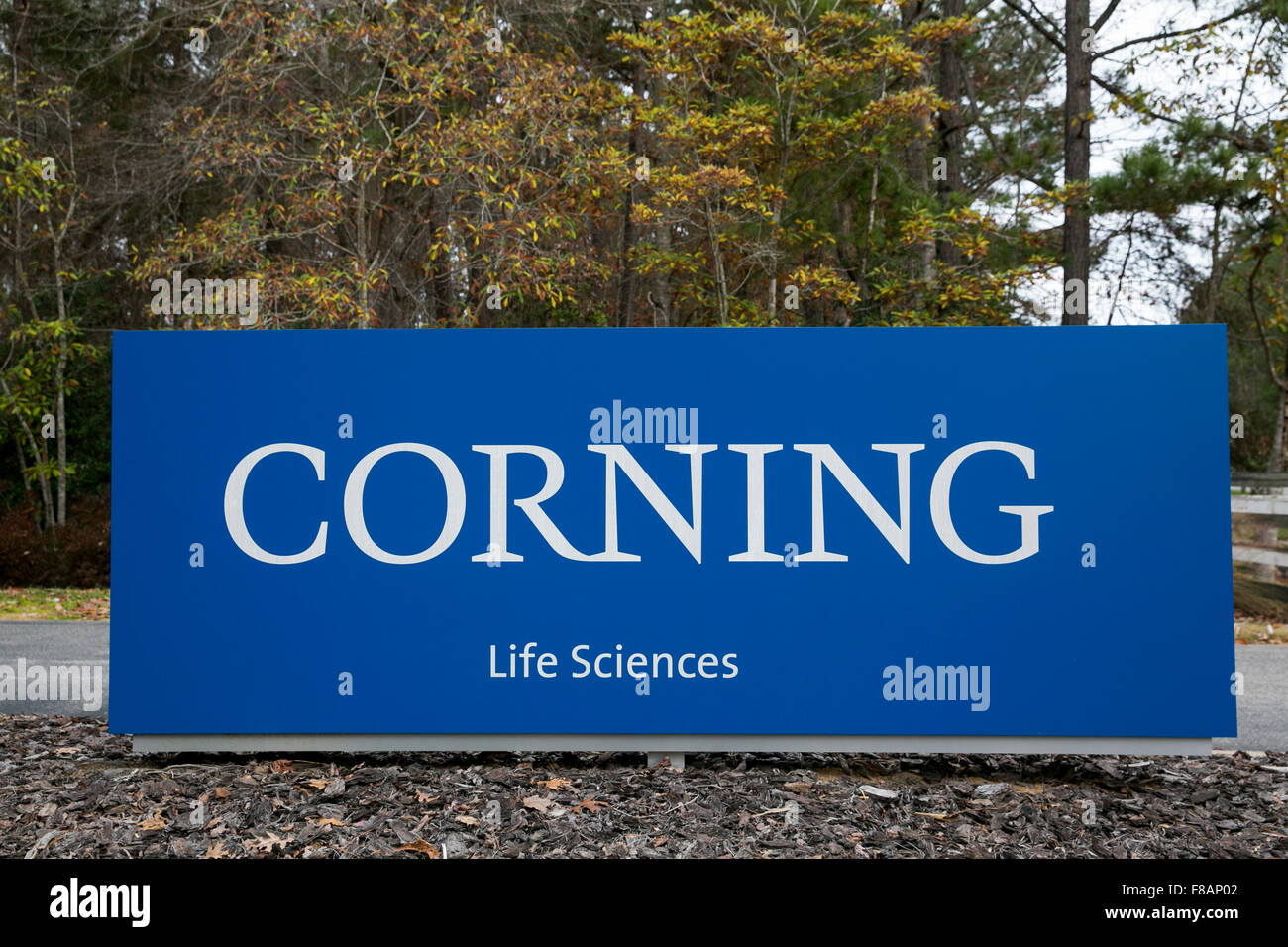 A logo sign outside of a facility occupied by Corning Life Sciences in ...
