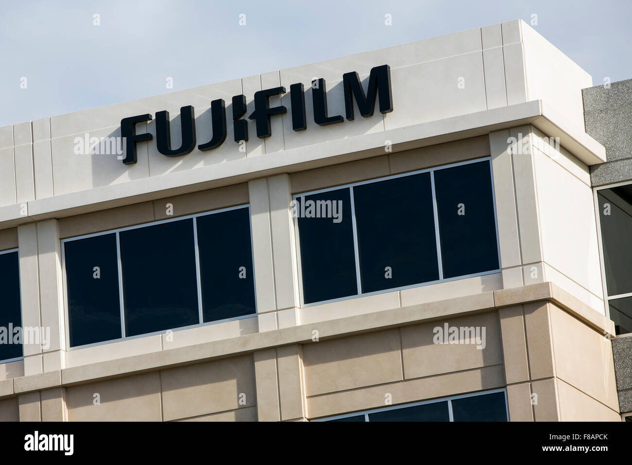 A logo sign outside of a facility occupied by Fujifilm Holdings ...