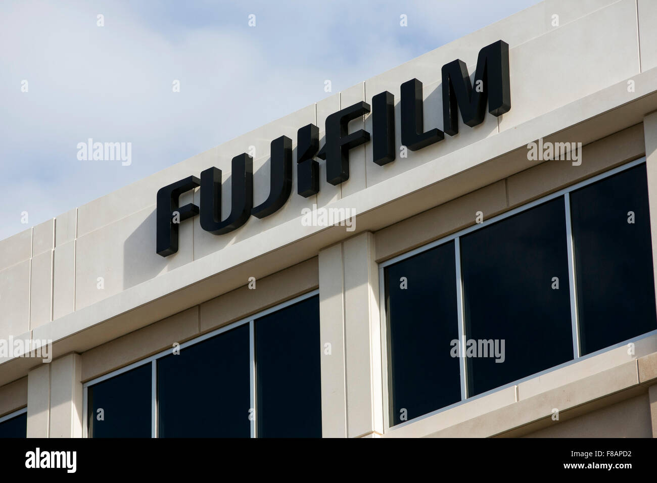 A logo sign outside of a facility occupied by Fujifilm Holdings ...