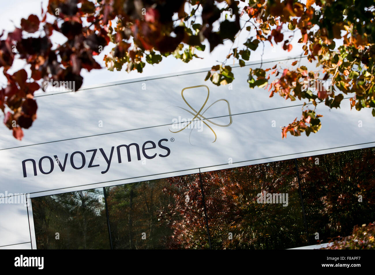 A logo sign outside of a facility occupied by Novozymes in Research ...