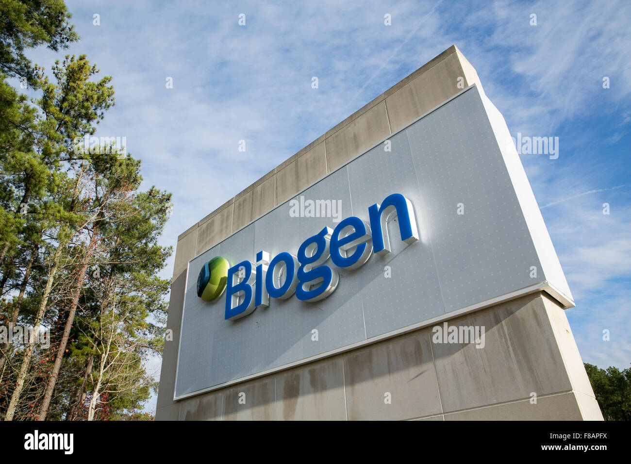 A logo sign outside of a facility occupied by Biogen in Research ...