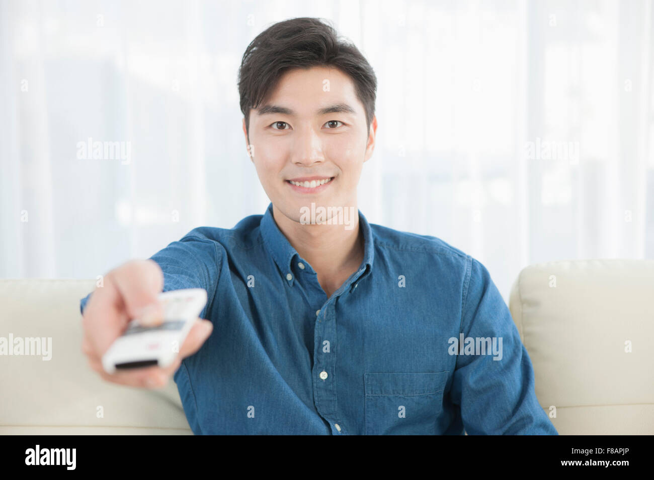 Man holding tv remote hi-res stock photography and images - Alamy