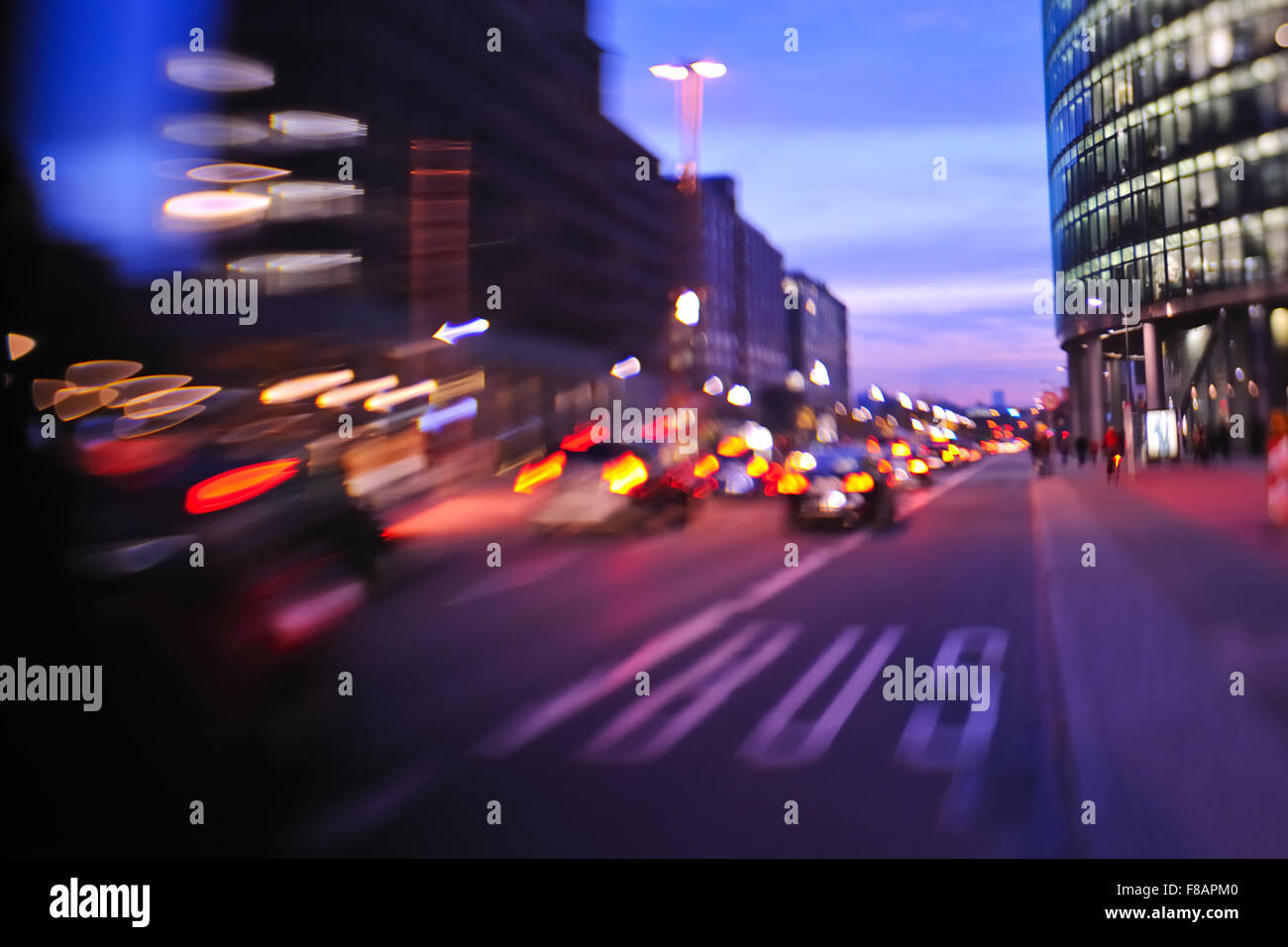 busy traffic scene of street in night with car traffic and vivid ...