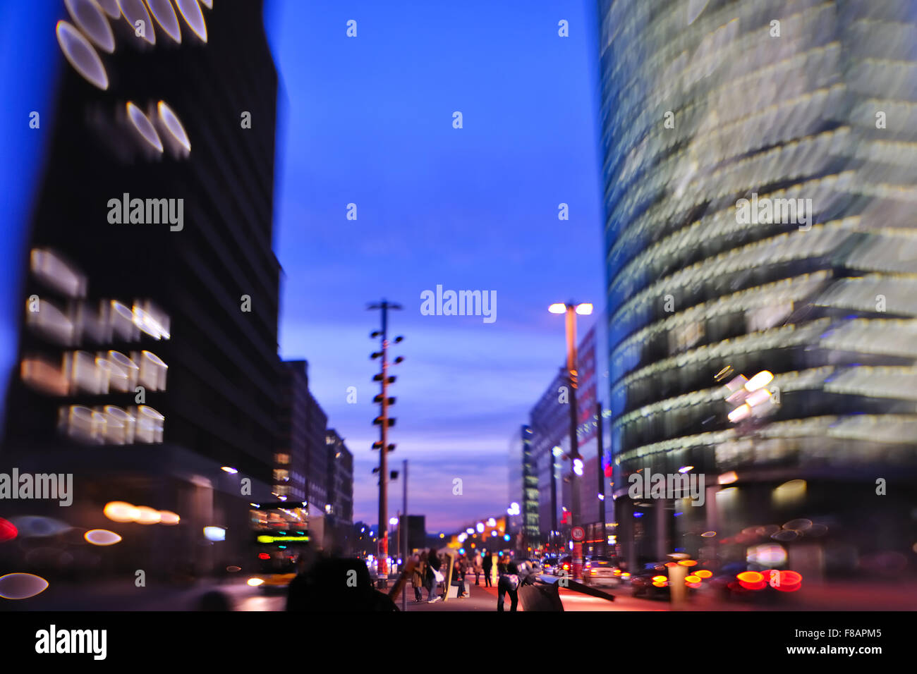 busy traffic scene of street in night with car traffic and vivid ...