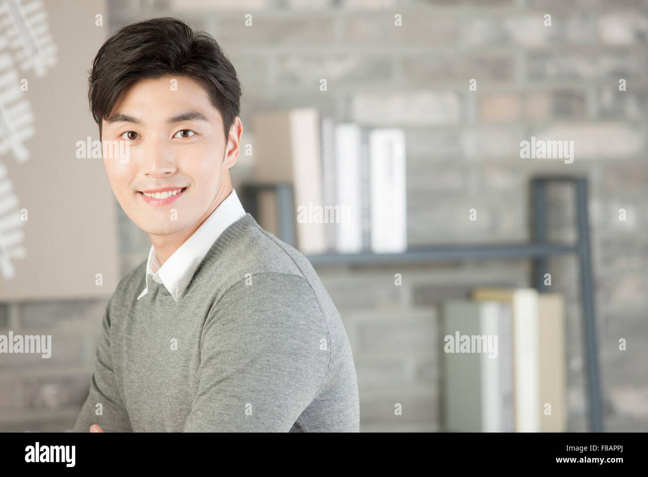 Portrait of young businessman staring at front with a big smile at cafe ...