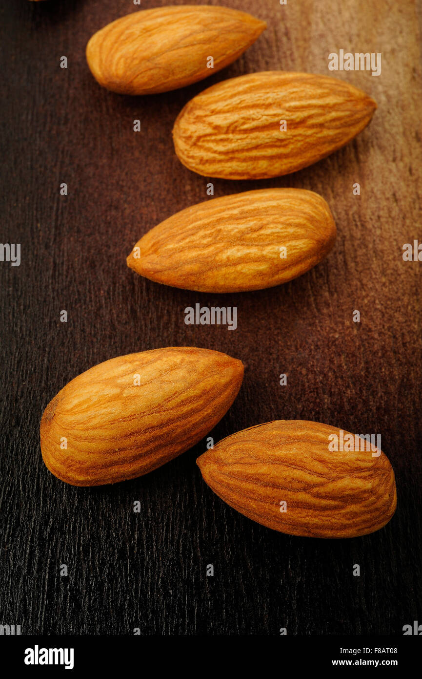 almonds on wooden background Stock Photo - Alamy