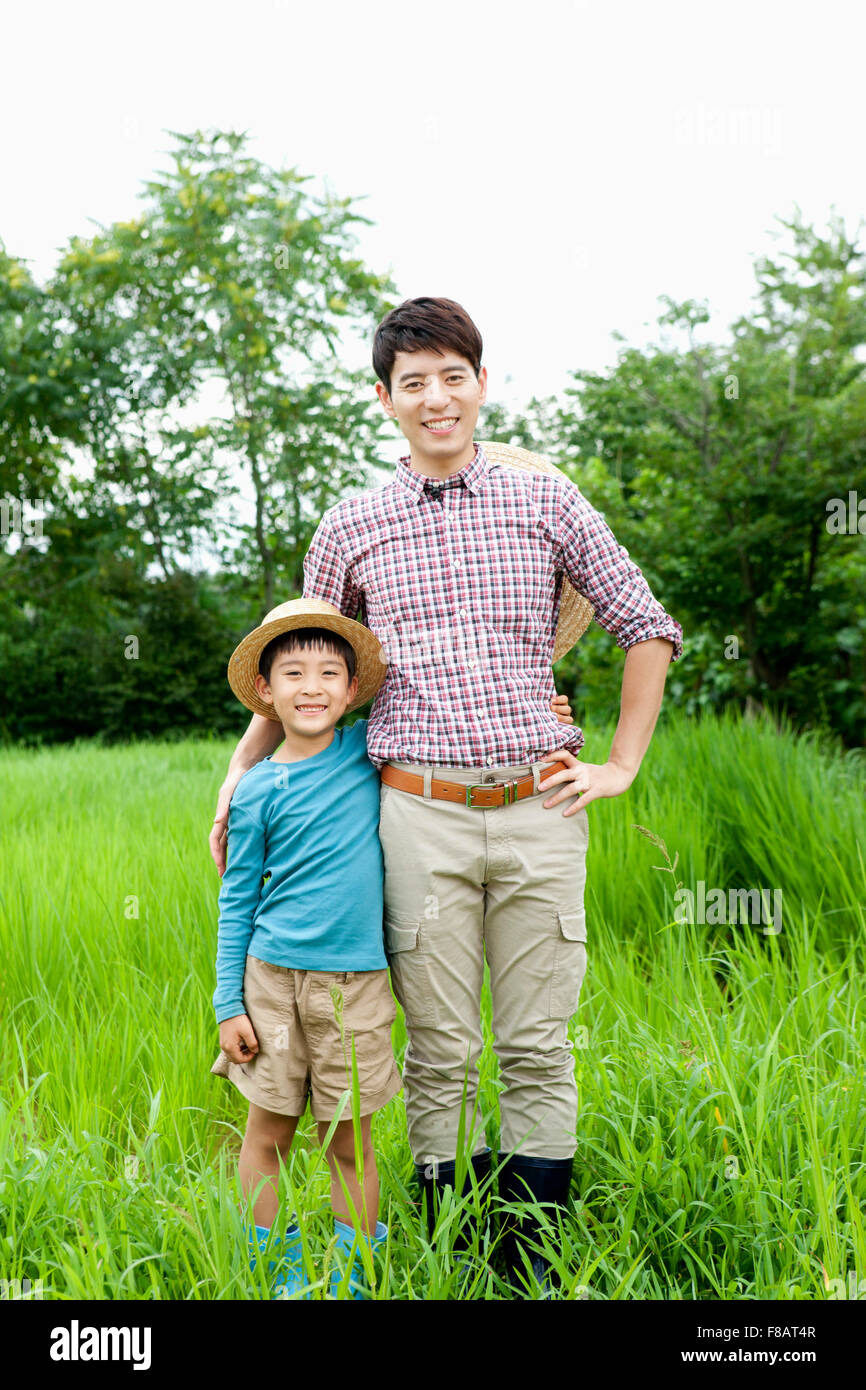 Loving father and boy standing staring at front with smiles at ...