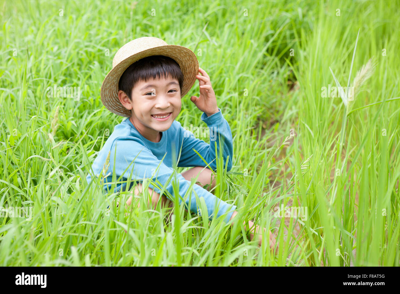Portrait of smiling boy staring at front at grassland Stock Photo - Alamy