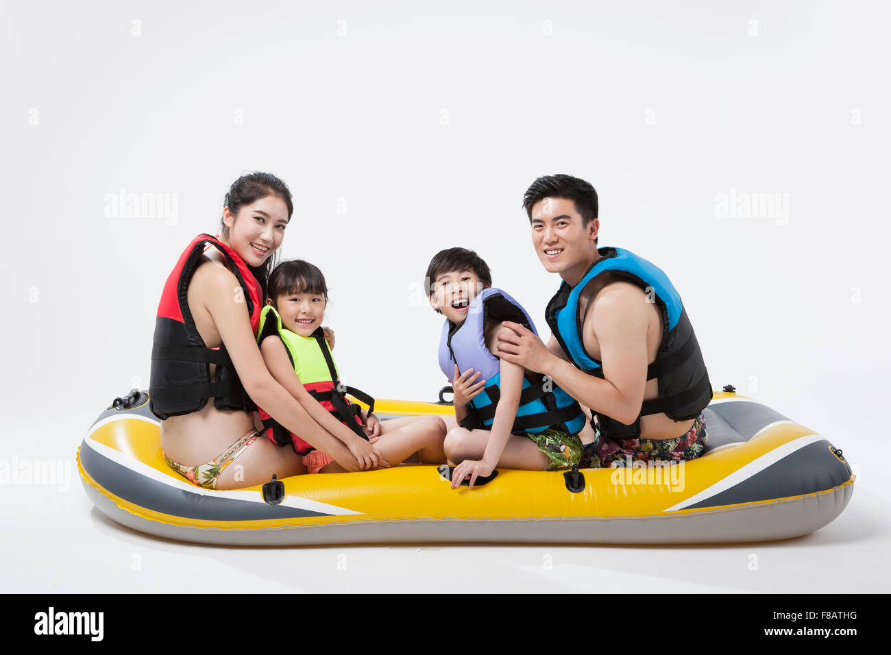 Family in life jackets riding a boat face to face Stock Photo - Alamy