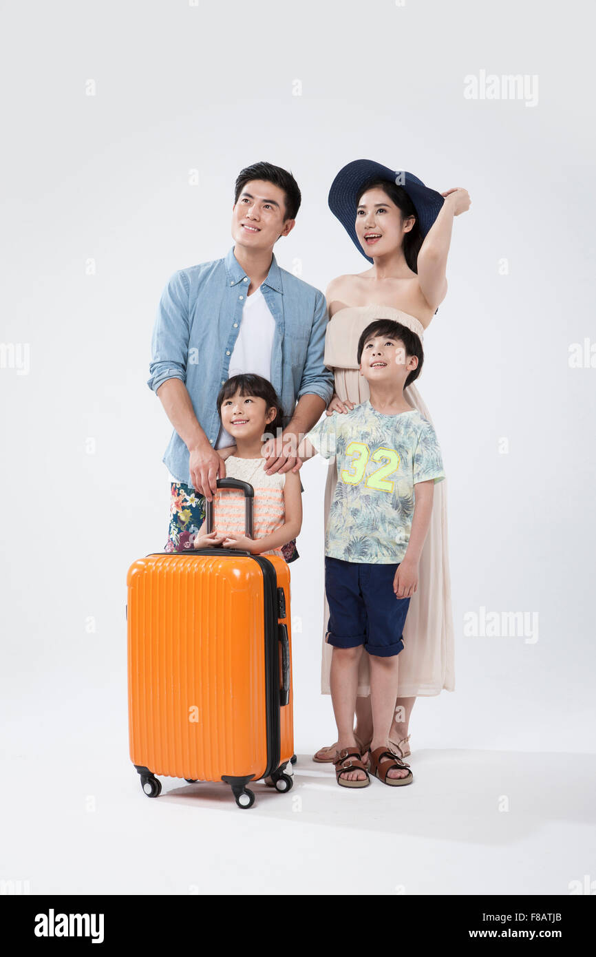 Family standing with a carrier looking up Stock Photo - Alamy