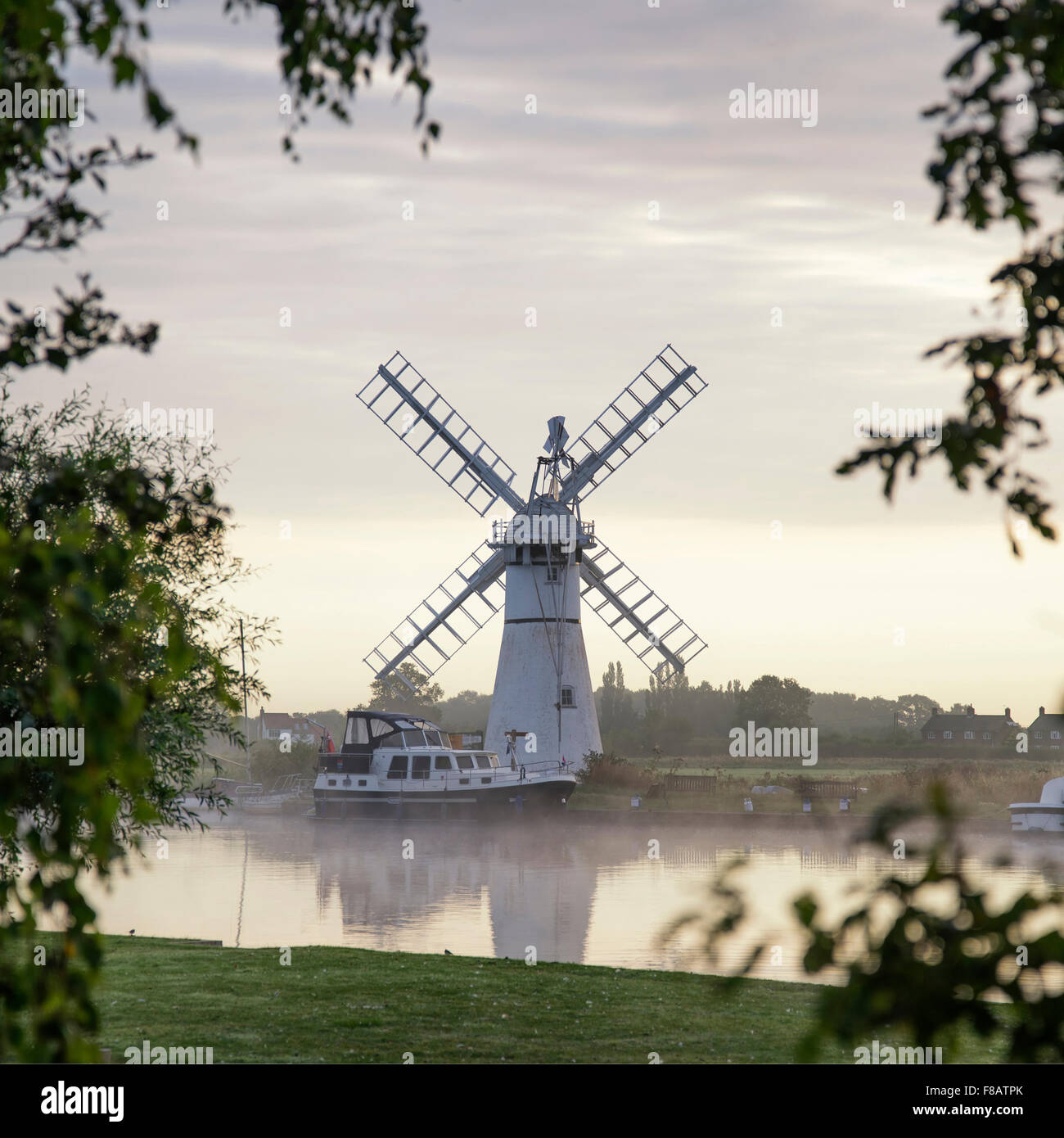 Stunning landscape of windmill and river at sunrise on Summer morning ...