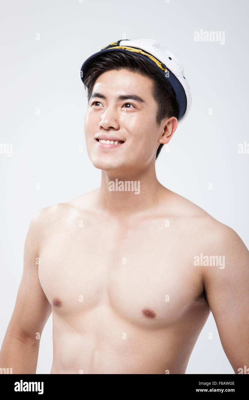 Portrait of young man wearing a captain cap with a smile Stock Photo ...