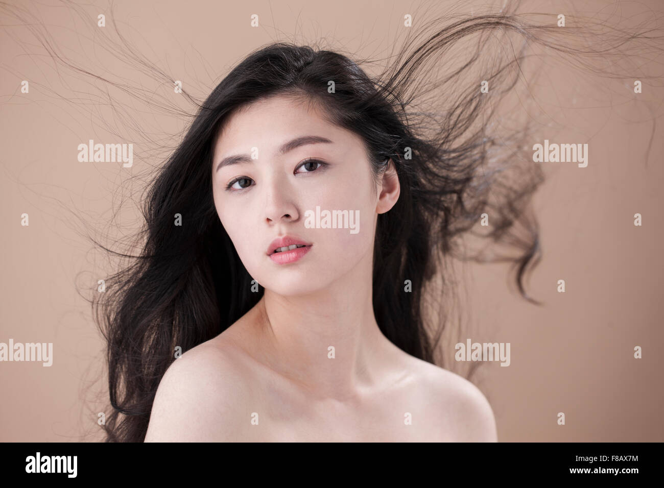 Portrait of young woman flapping hair Stock Photo - Alamy