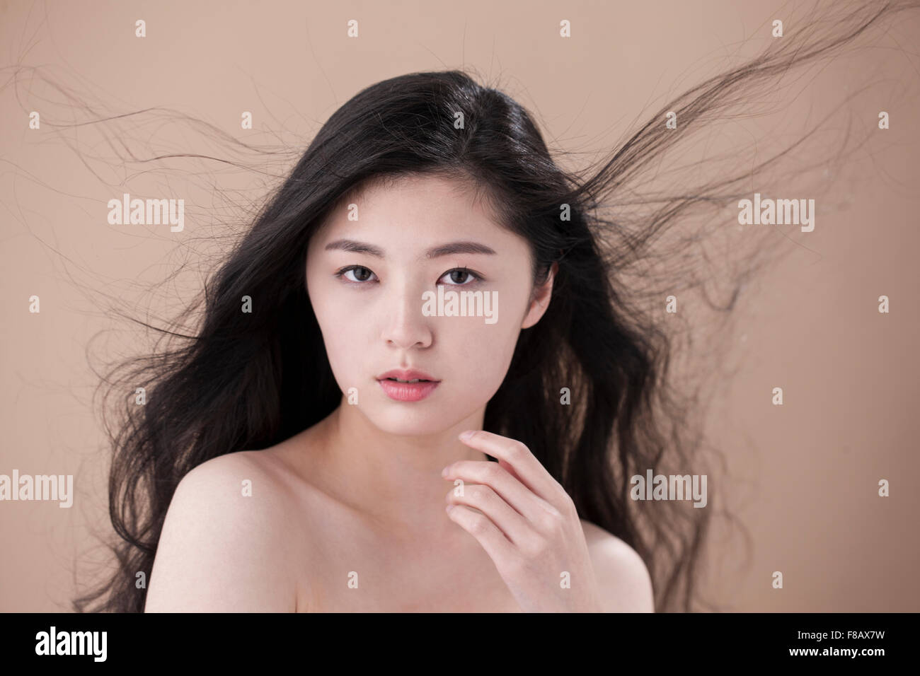 Portrait of young woman flapping hair Stock Photo - Alamy
