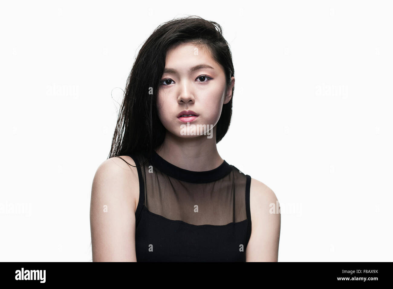 Portrait of young woman with long hair staring at front Stock Photo - Alamy