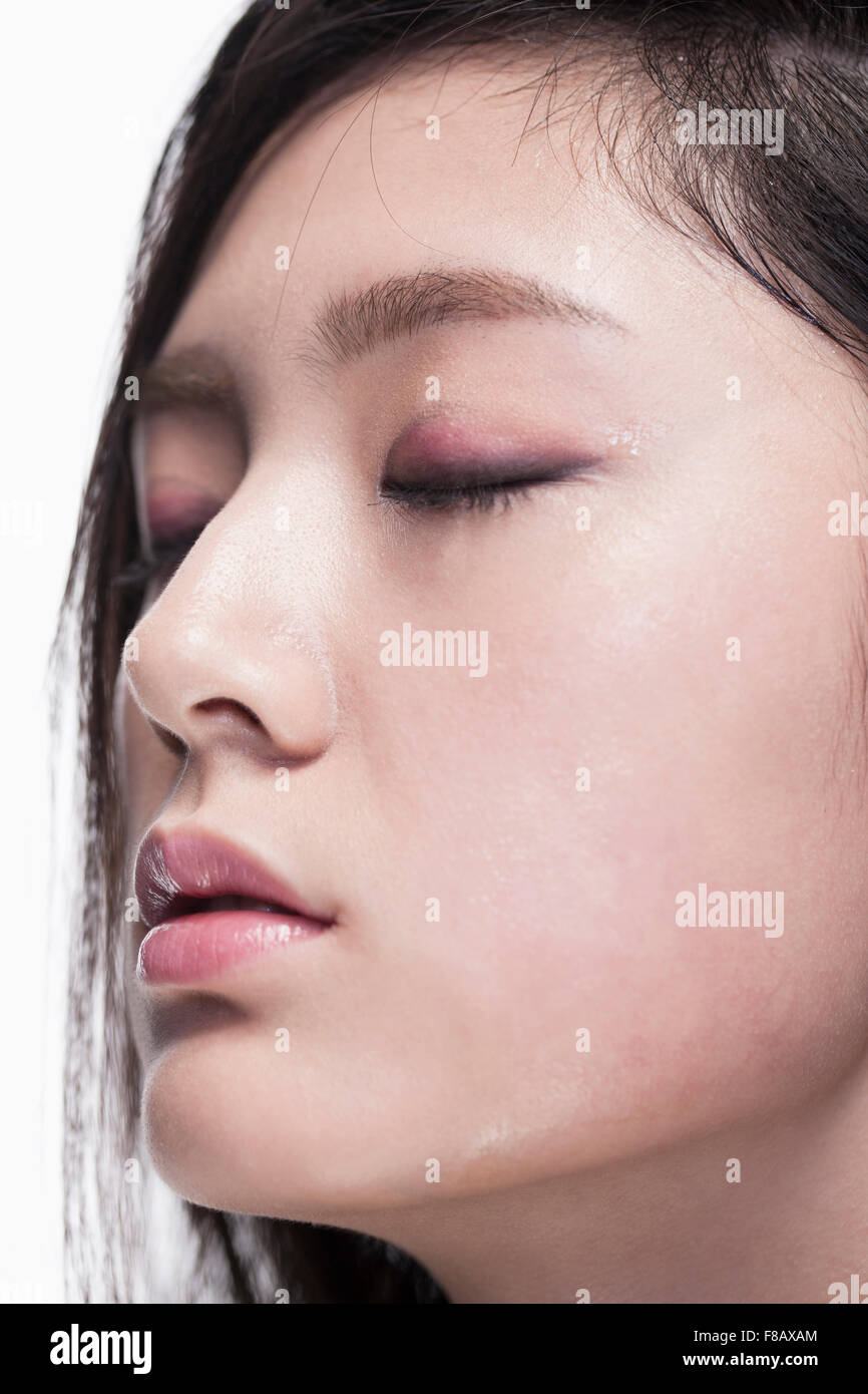 Close up face of young woman closing eyes Stock Photo - Alamy