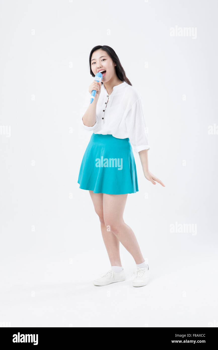 Young smiling woman singing staring at front Stock Photo - Alamy