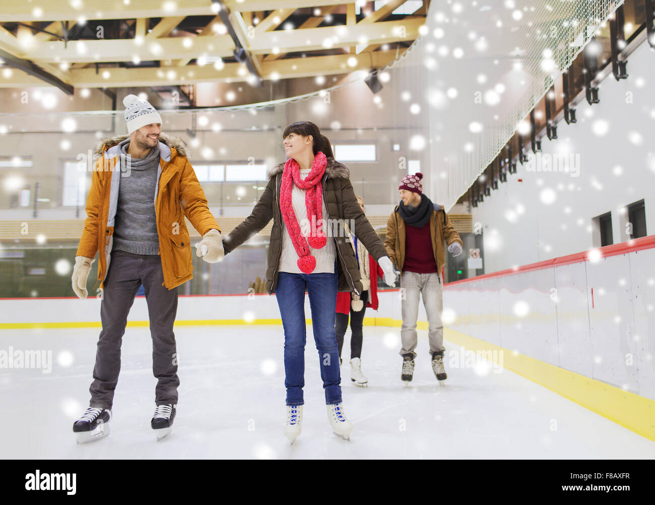 happy friends on skating rink Stock Photo - Alamy