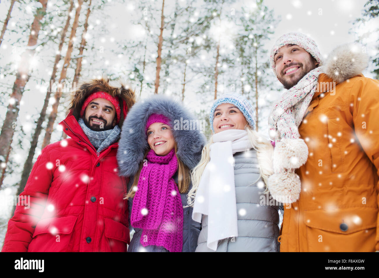 group of smiling men and women in winter forest Stock Photo - Alamy