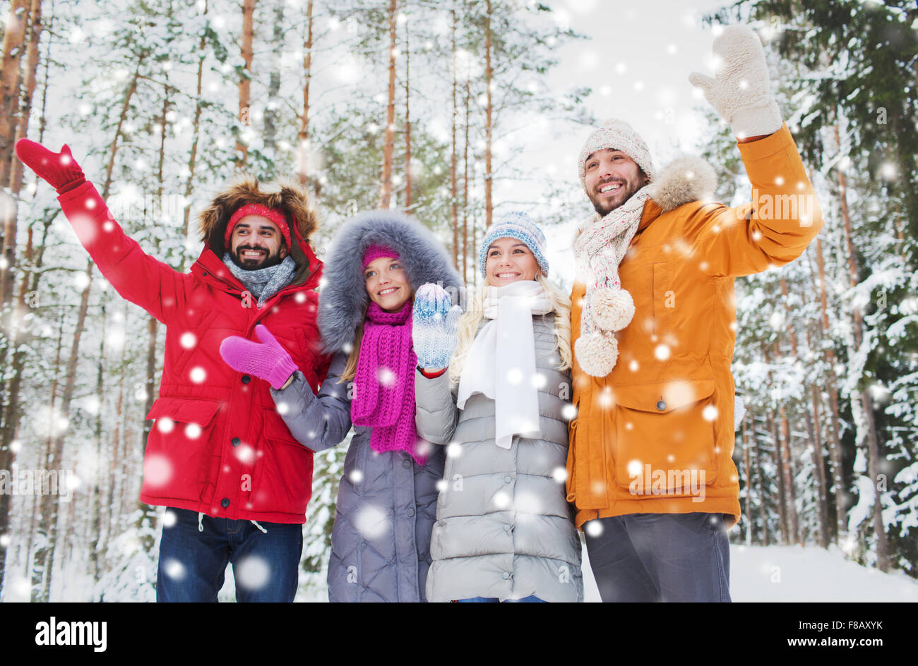 group of friends waving hands in winter forest Stock Photo - Alamy
