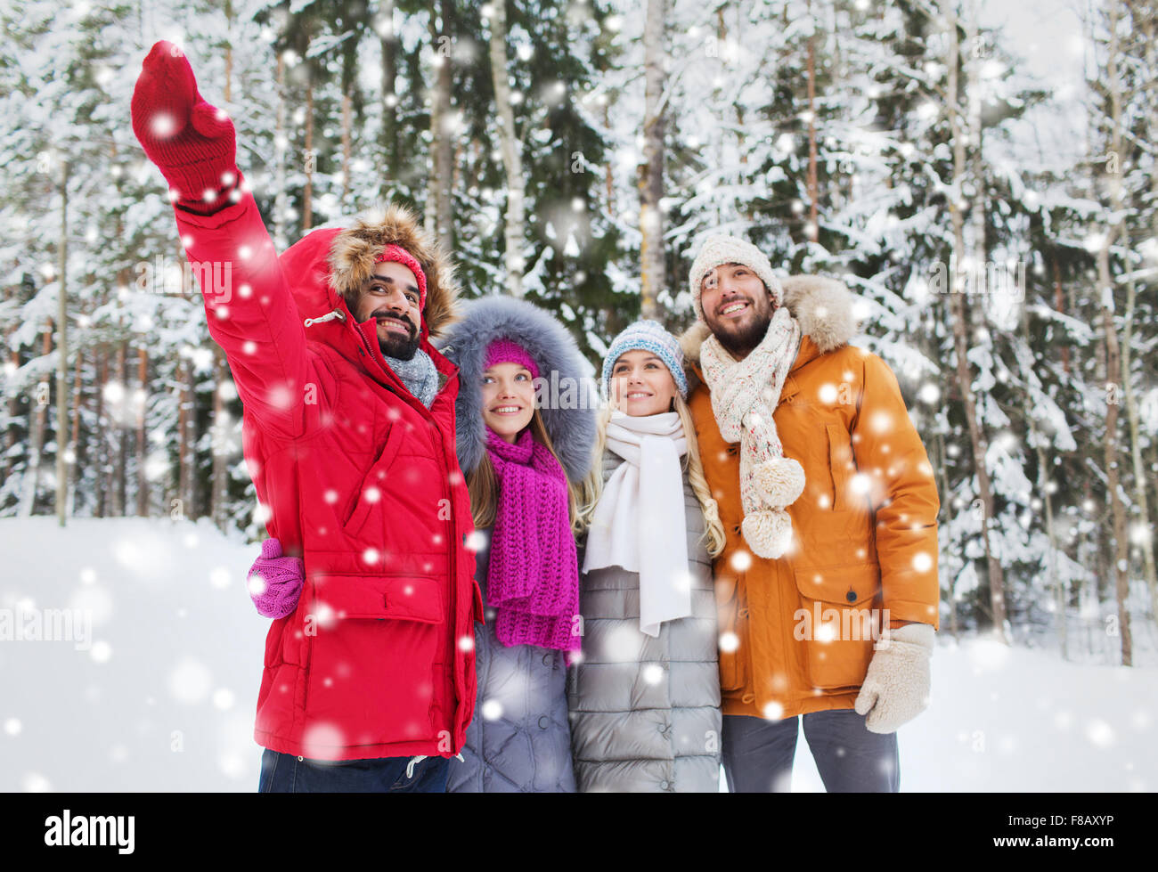group of smiling men and women in winter forest Stock Photo - Alamy