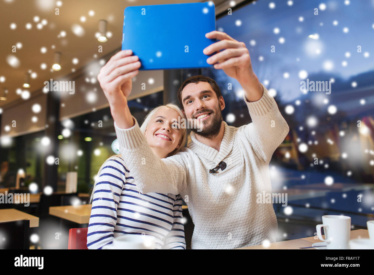 happy couple with tablet pc taking selfie at cafe Stock Photo - Alamy