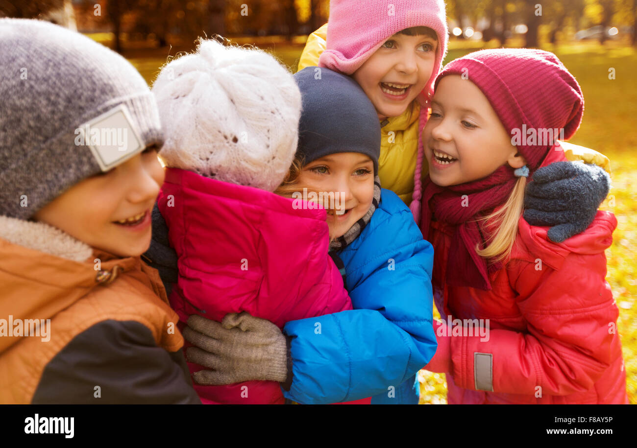 group of happy children hugging in autumn park Stock Photo - Alamy