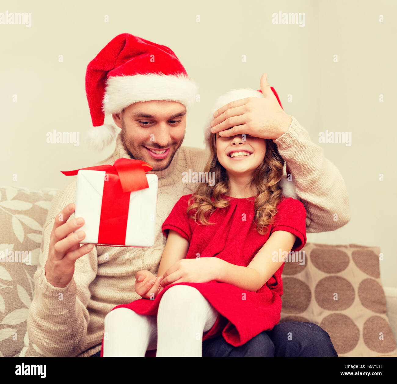 smiling father surprises daughter with gift box Stock Photo - Alamy