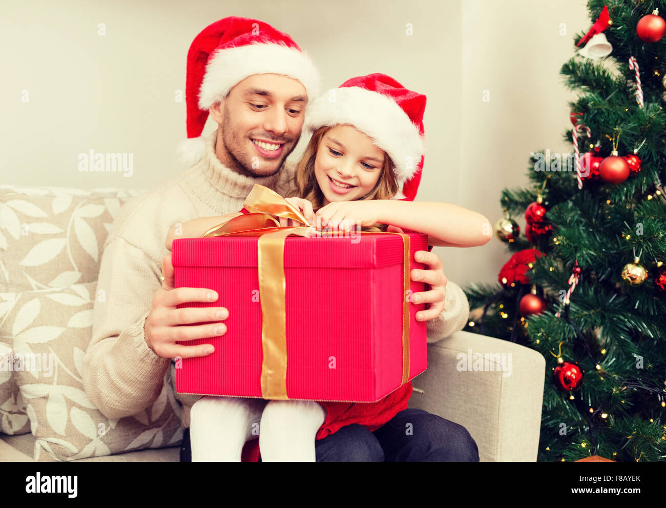 smiling father and daughter opening gift box Stock Photo - Alamy