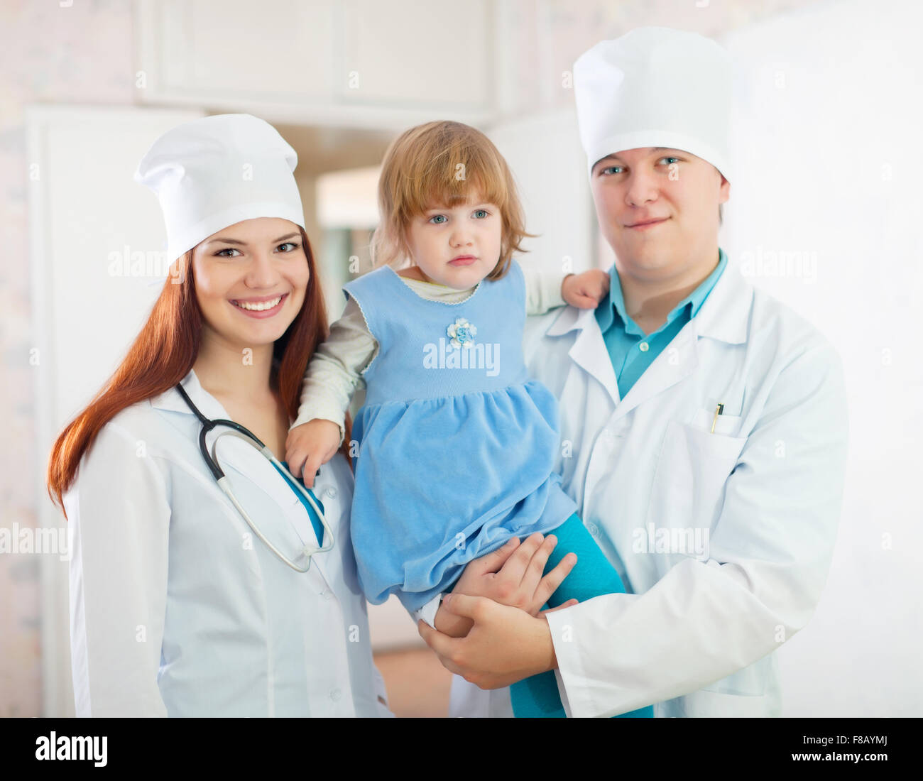 friendly doctors with baby girl in the clinic Stock Photo - Alamy