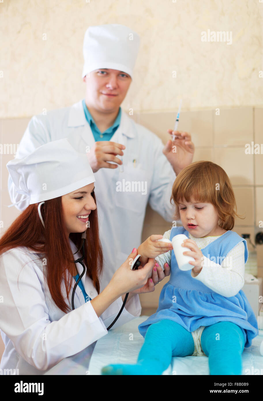 Doctors working with baby girl in the clinic Stock Photo - Alamy