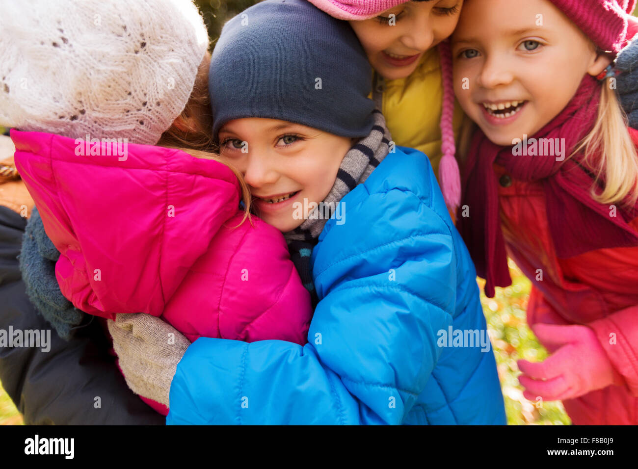 group of happy children hugging in autumn park Stock Photo - Alamy