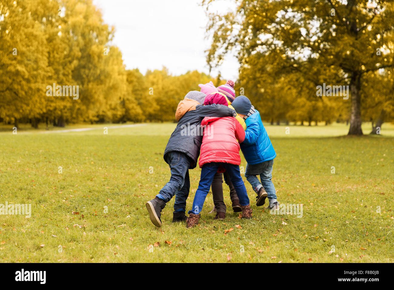 group of happy children hugging in autumn park Stock Photo - Alamy