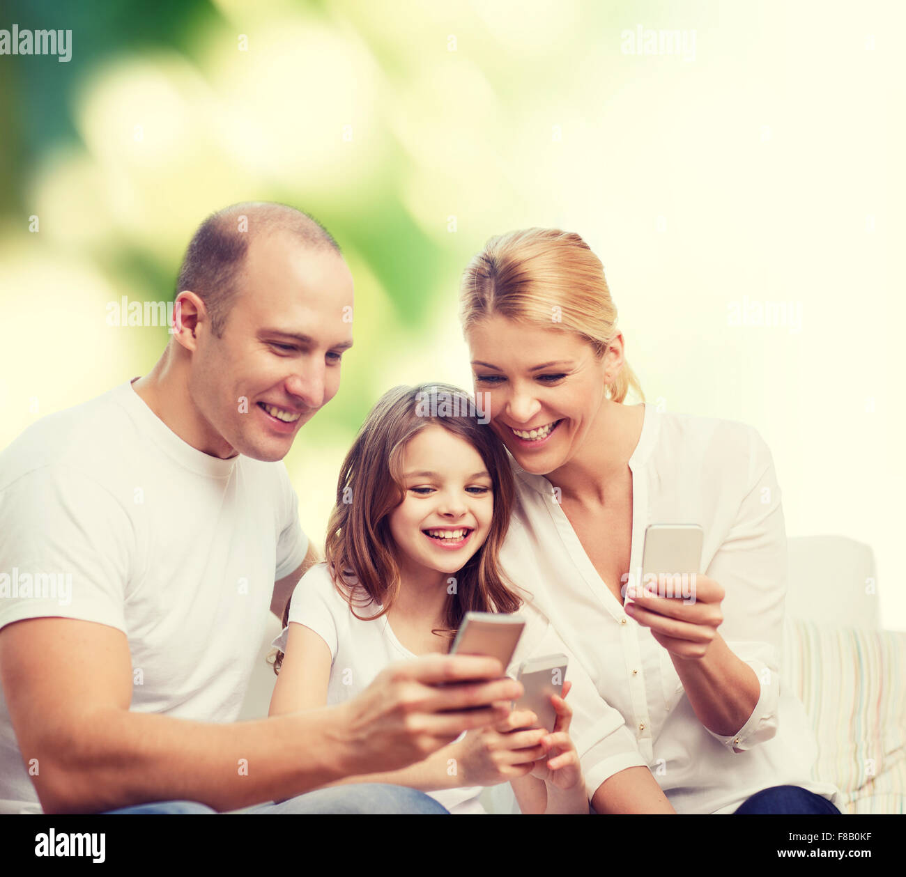 happy family with smartphones Stock Photo - Alamy