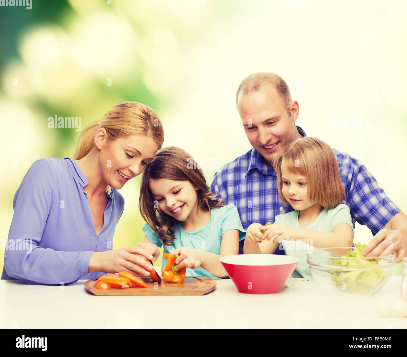 happy family with two kids making dinner at home Stock Photo - Alamy