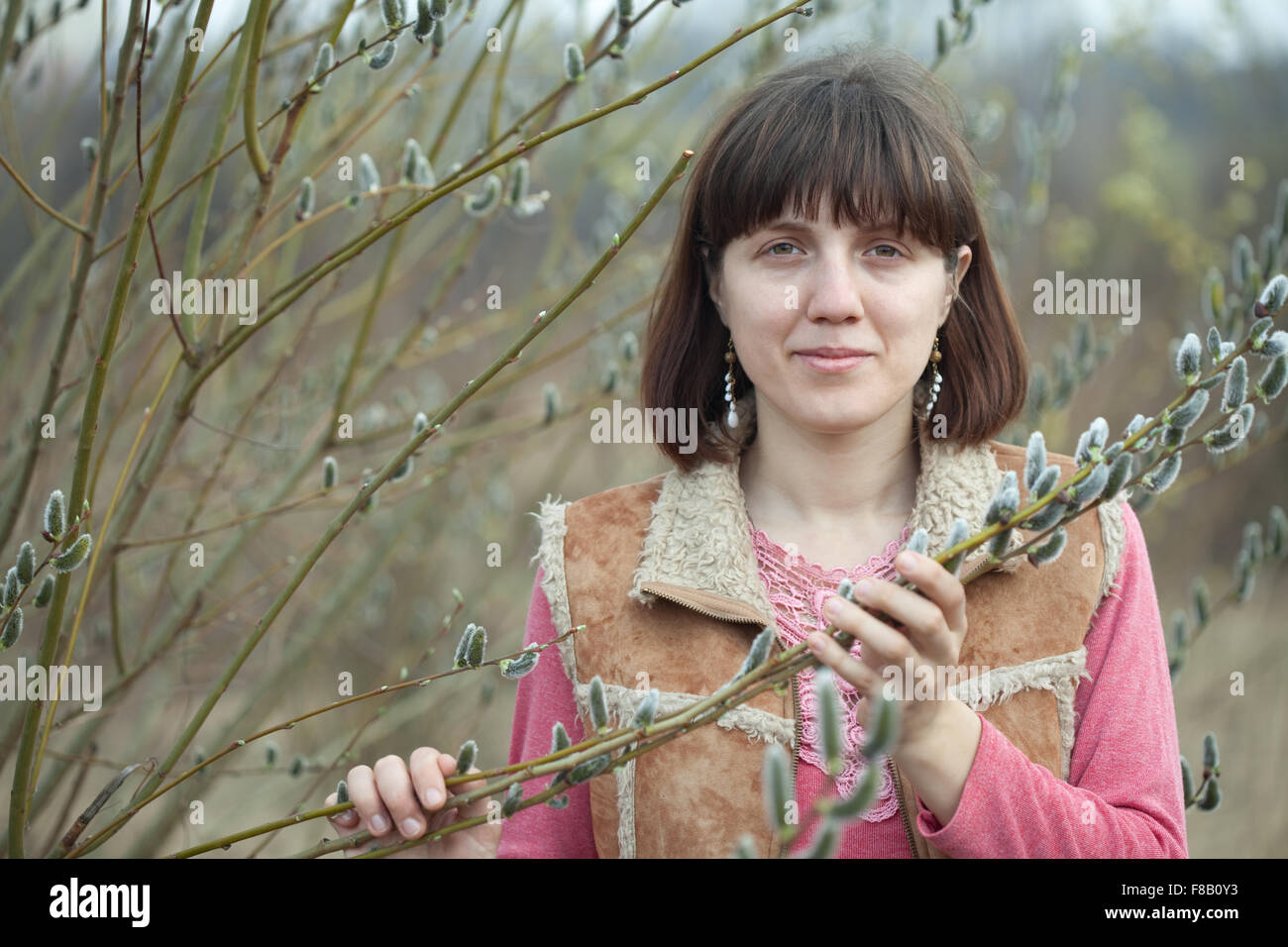 portrait of girl against spring Willow branches with buds Stock Photo ...