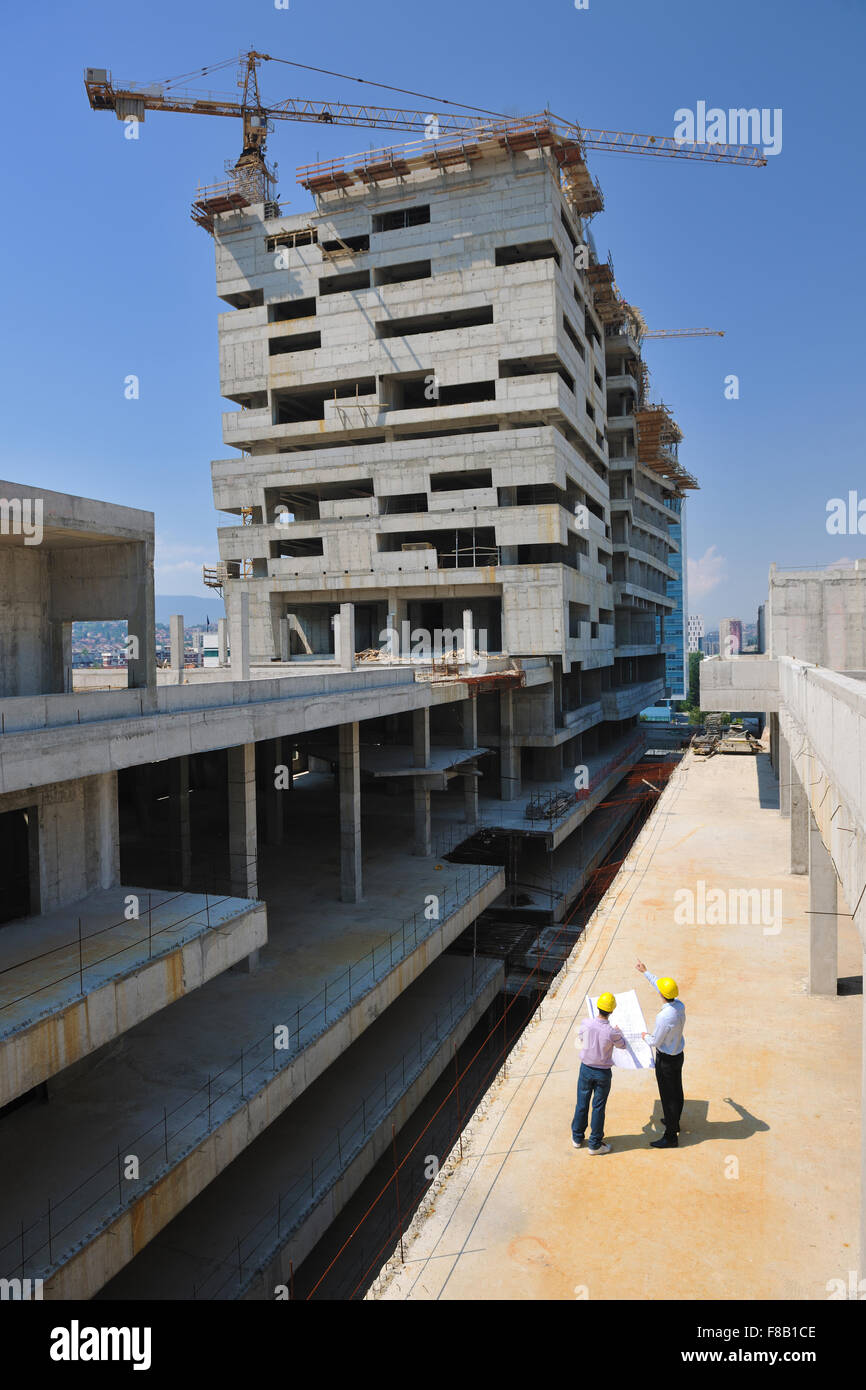 Team of architects people in group on construciton site check documents ...