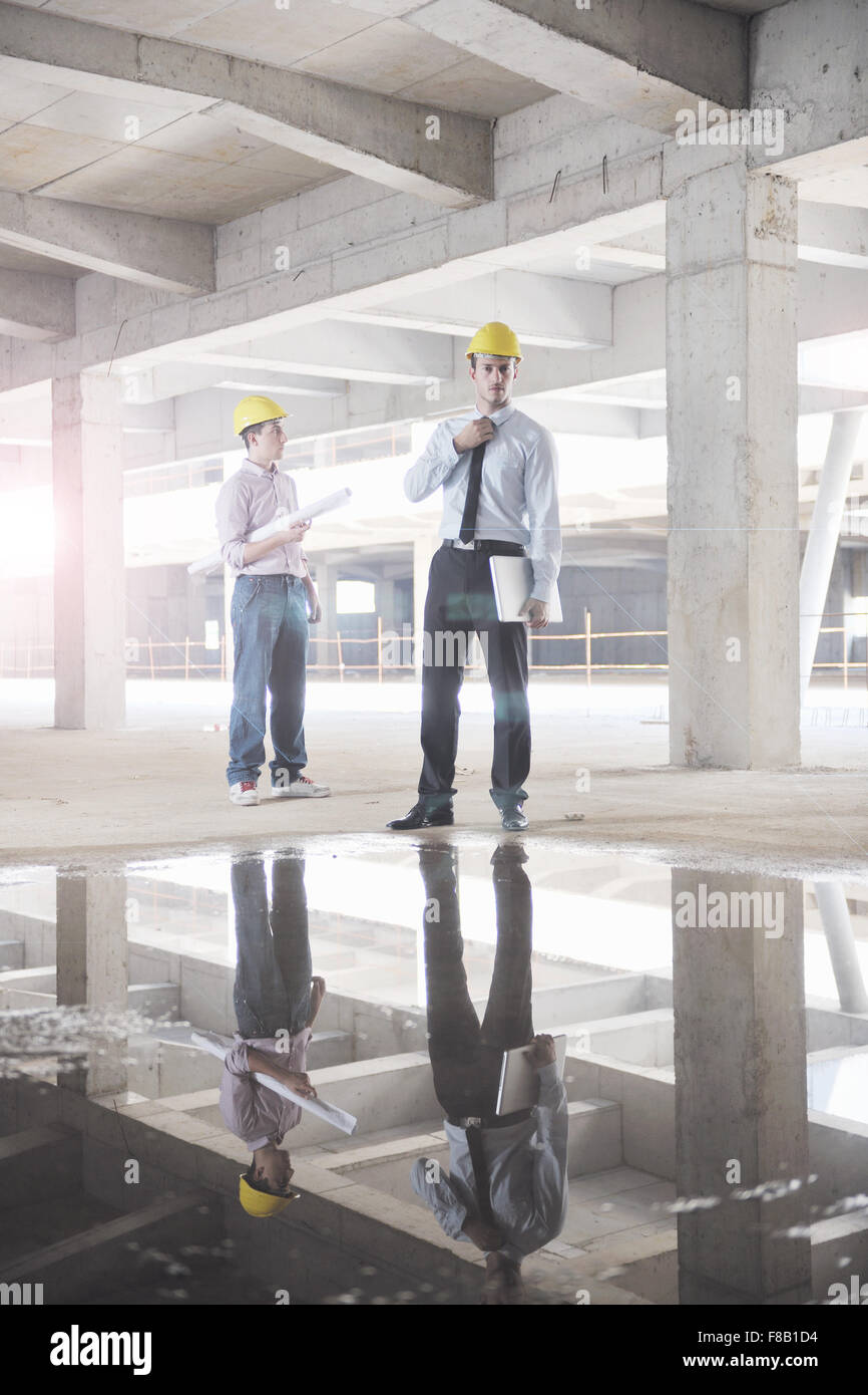 Team of architects people in group on construciton site check documents ...