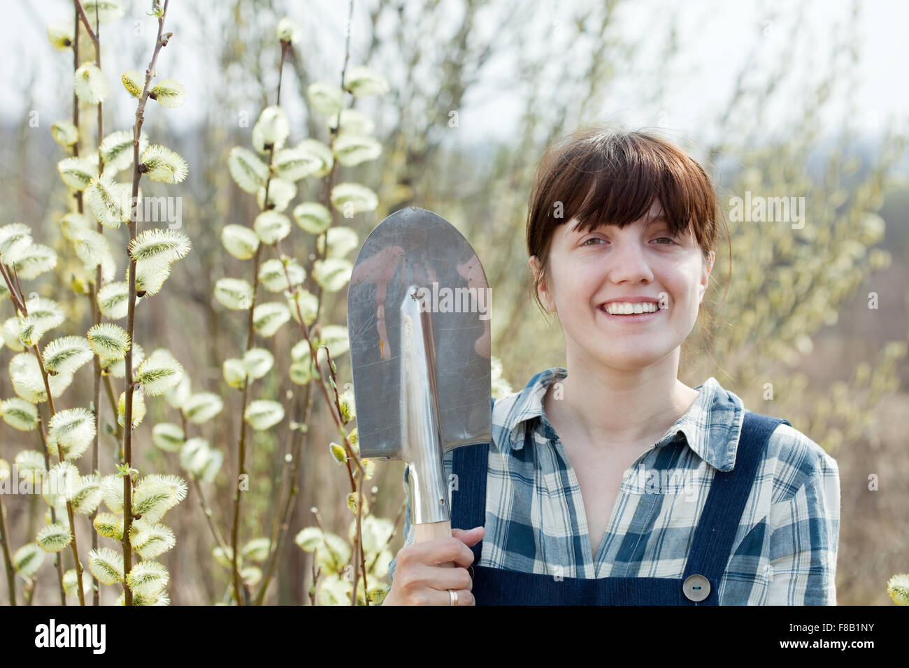 Happy female farmer with shovel in spring Stock Photo - Alamy