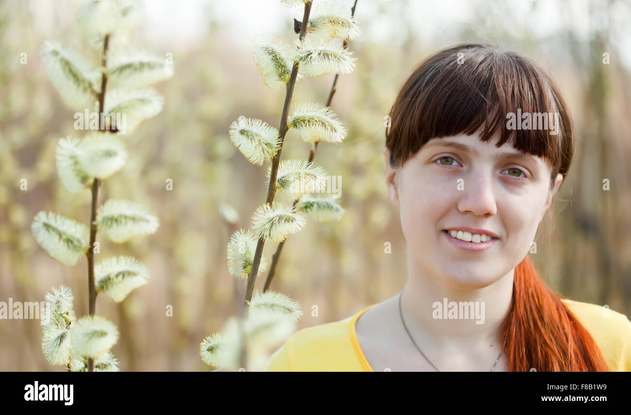 Smiling young woman in spring willow twig with buds outdoor Stock Photo ...