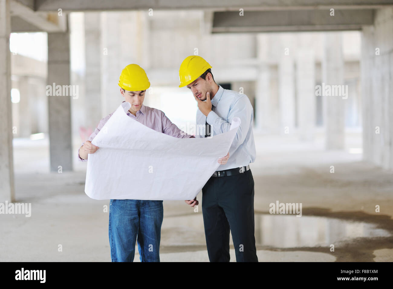 Team of architects people in group on construciton site check documents ...