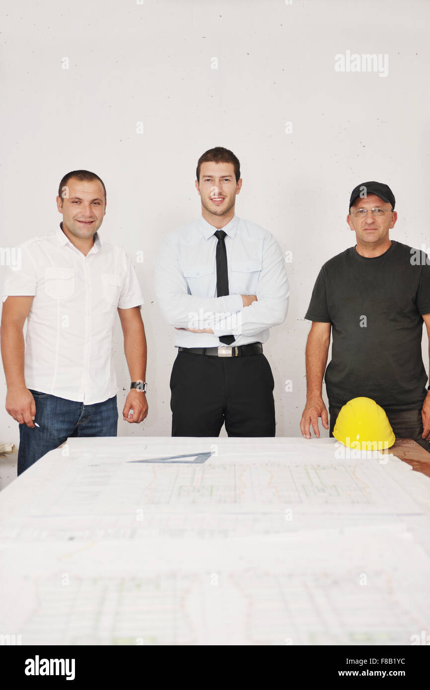 Team of architects people in group on construciton site check documents ...