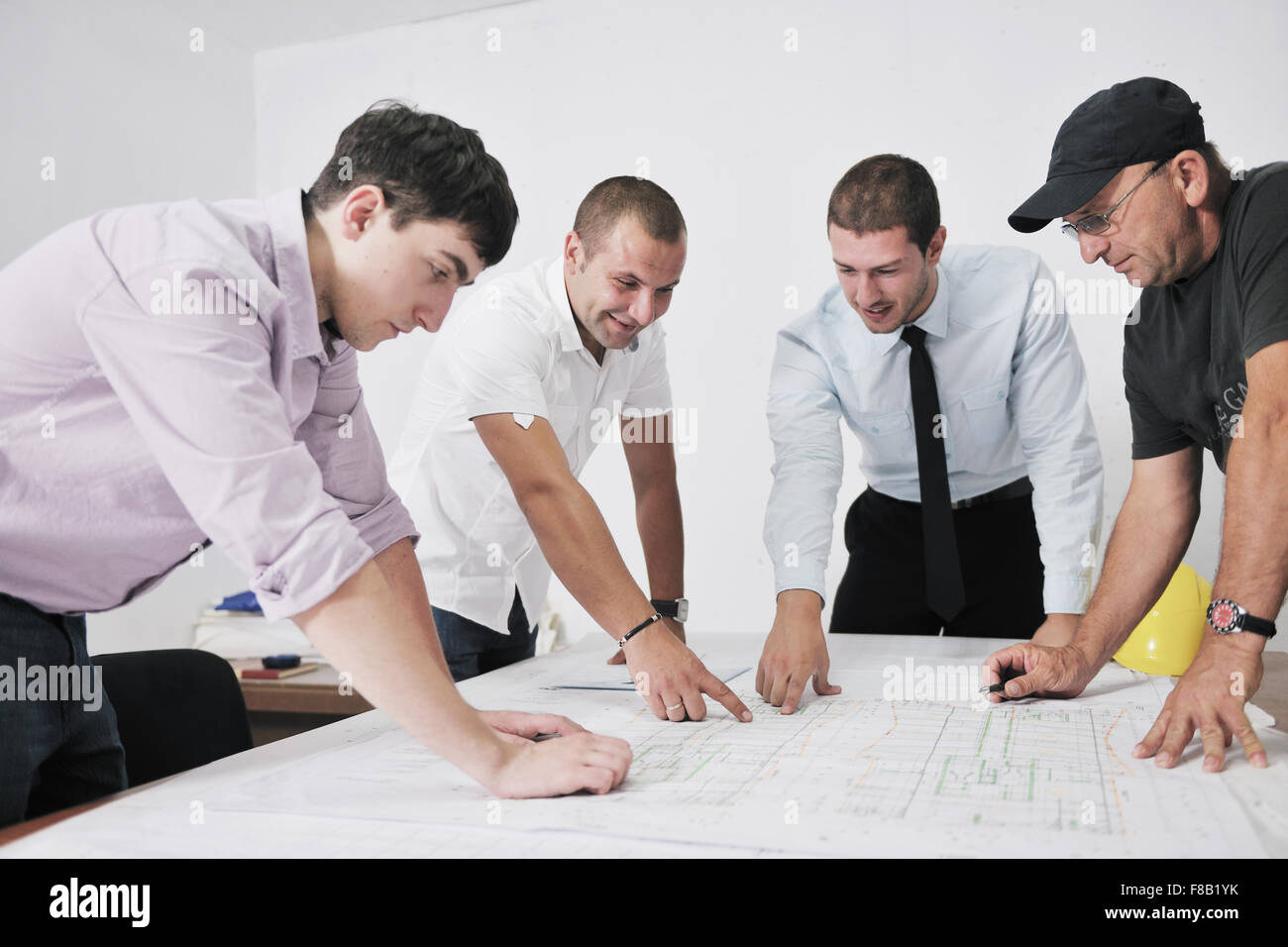 Team of architects people in group on construciton site check documents ...