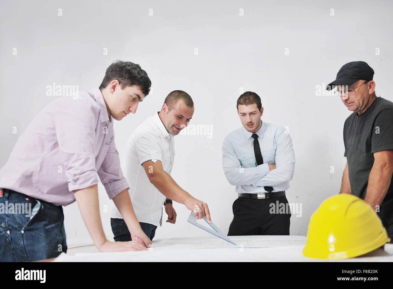 Team of architects people in group on construciton site check documents ...